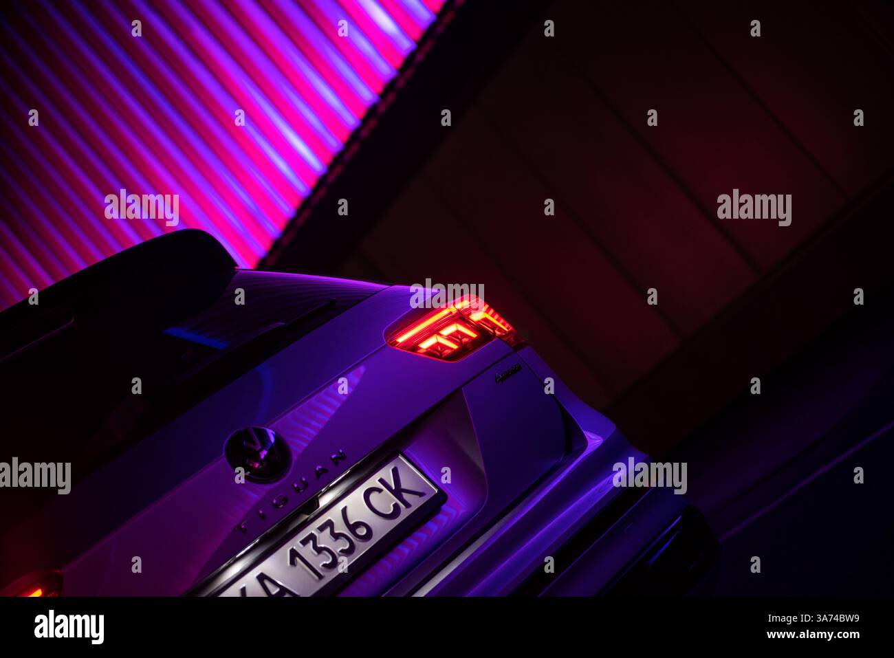 Volkswagen Tiguan on a street with purple glowing lights. Rear end of ...