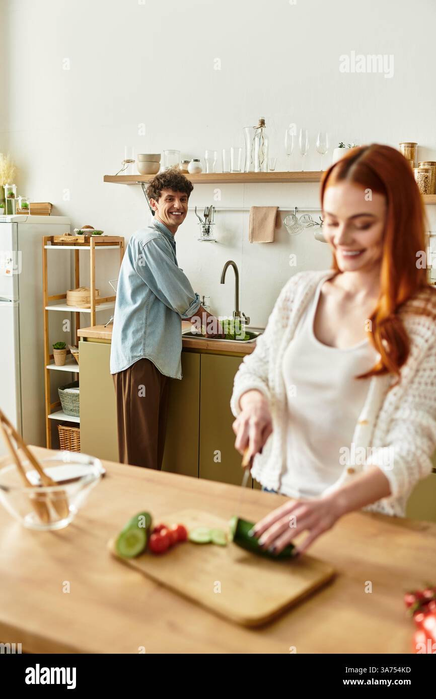 A young couple shares joy and connection while cooking a meal together ...
