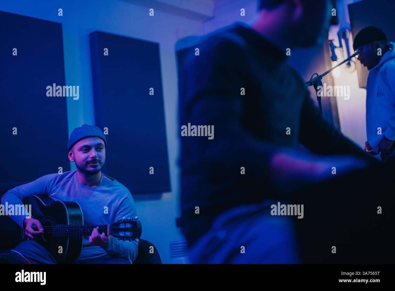 Multiracial group of musicians collaborating in a recording studio ...