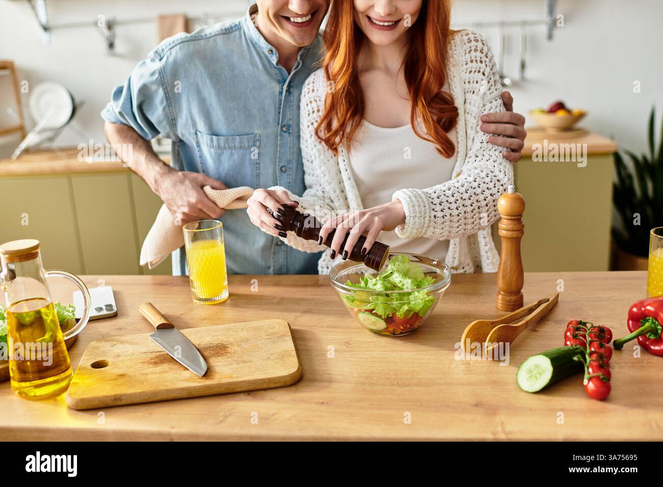 Young couple shares joyful moments in their cozy kitchen, crafting a ...
