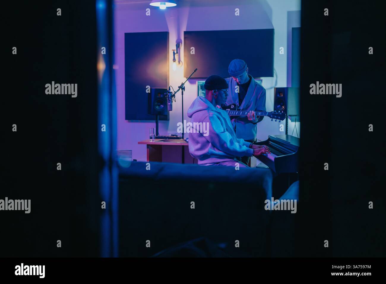 Musicians collaborating in a creative studio environment with ...