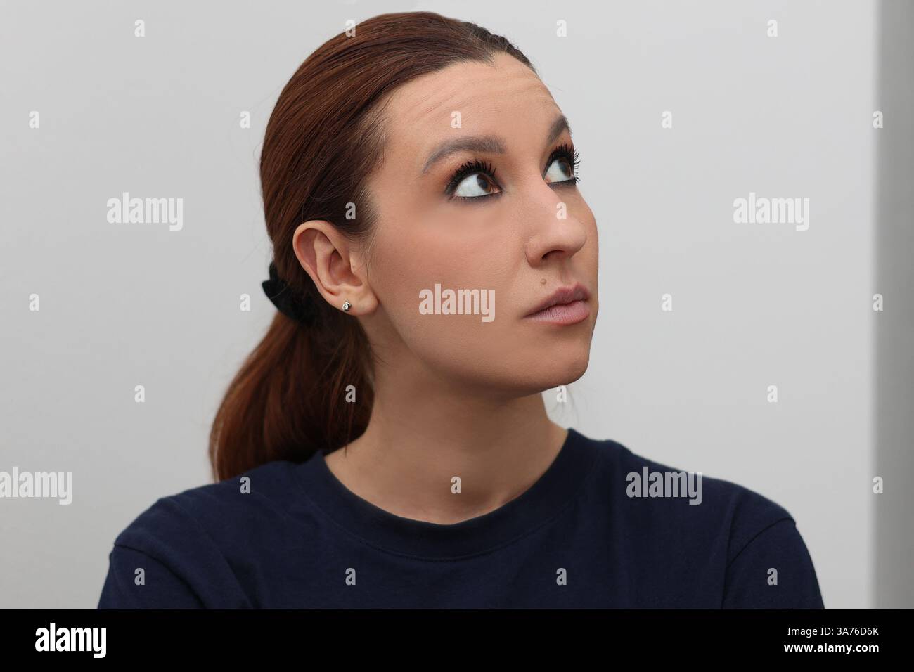 beautiful girl looks thoughtfully to the side up. mysterious look ...