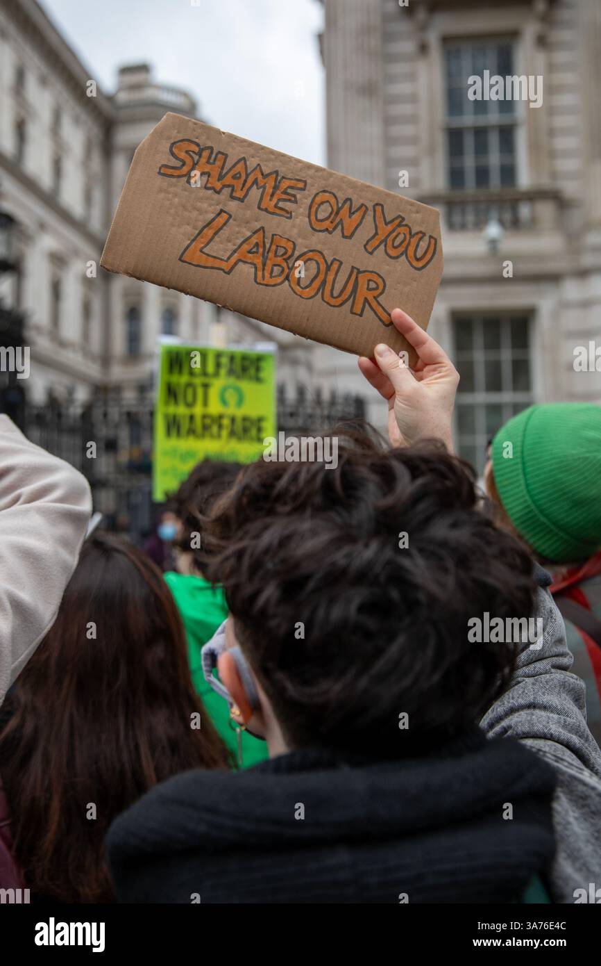 A campaigner holds a placard during a disability rights demonstration ...