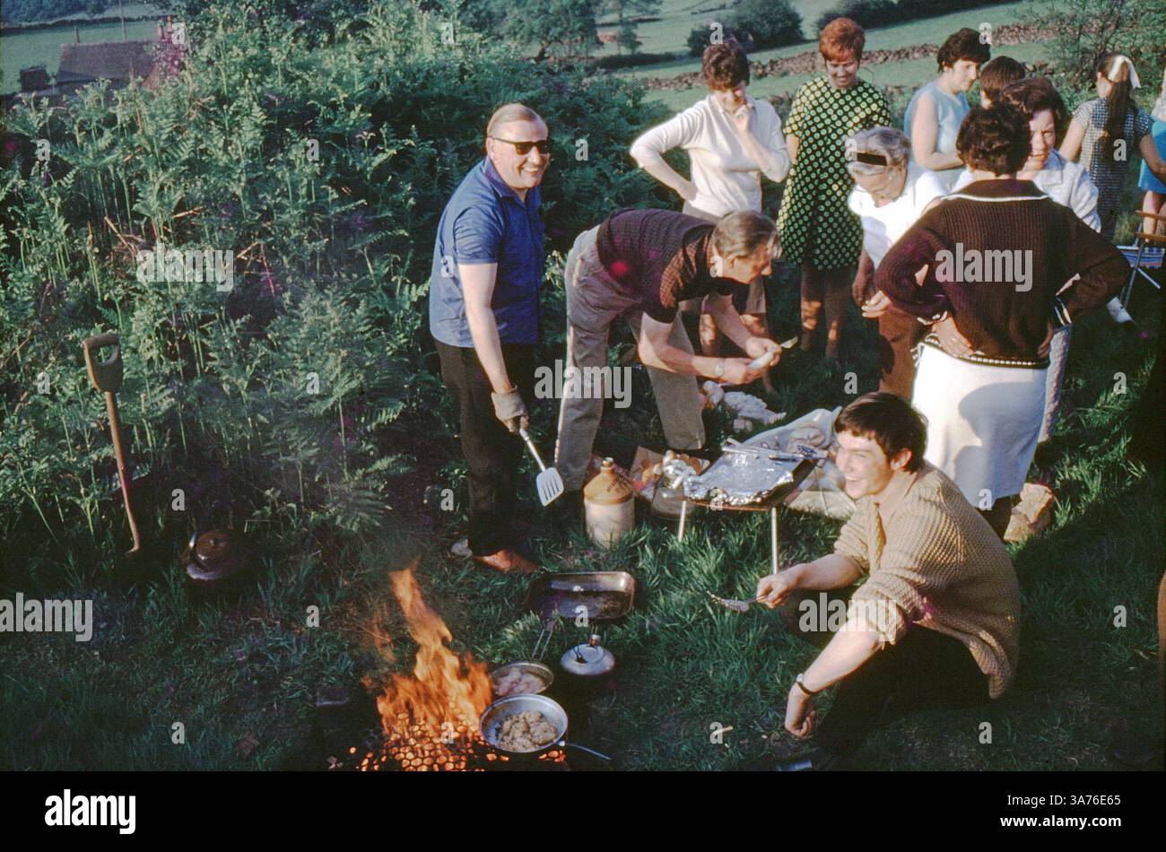 A joyful summer picnic in the English countryside during the 1960s ...