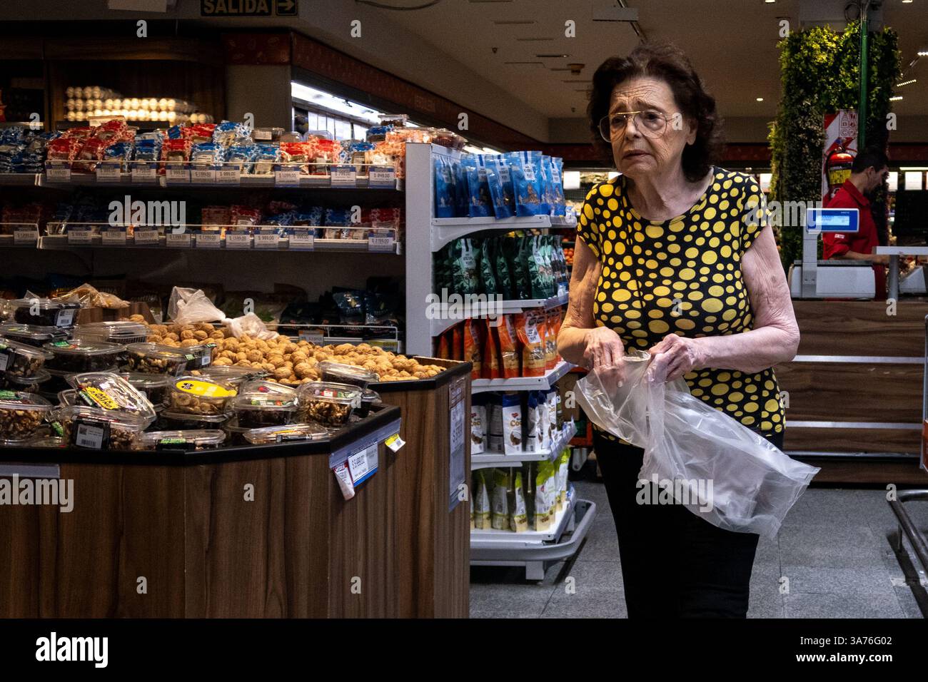 Buenos Aires, Argentina. 25th Mar, 2025. A woman shops in a supermarket ...