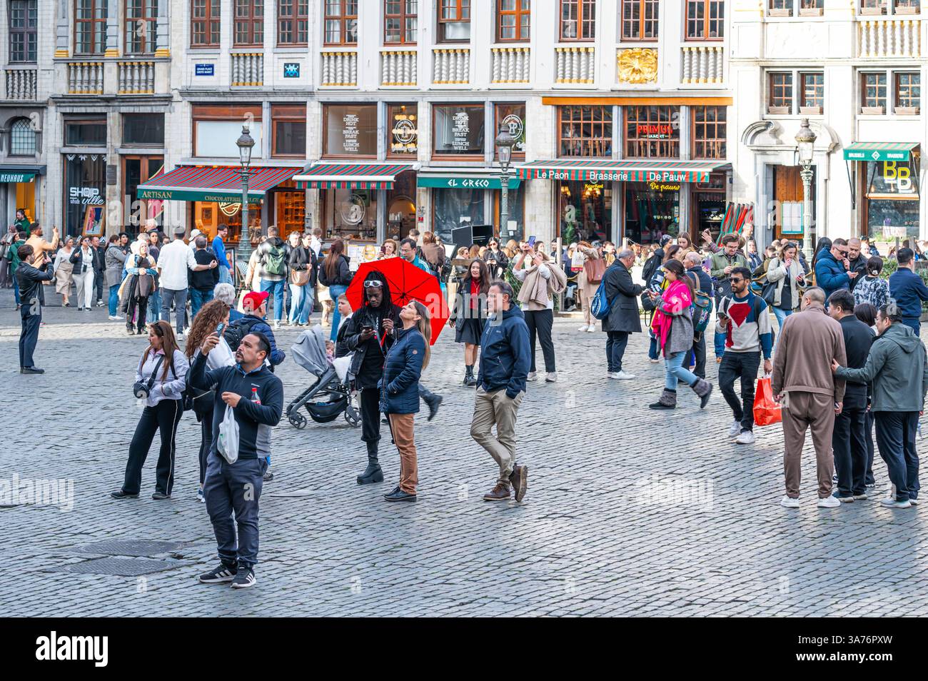 Mixed crowd of people visiting Grand Place in Brussels old town ...