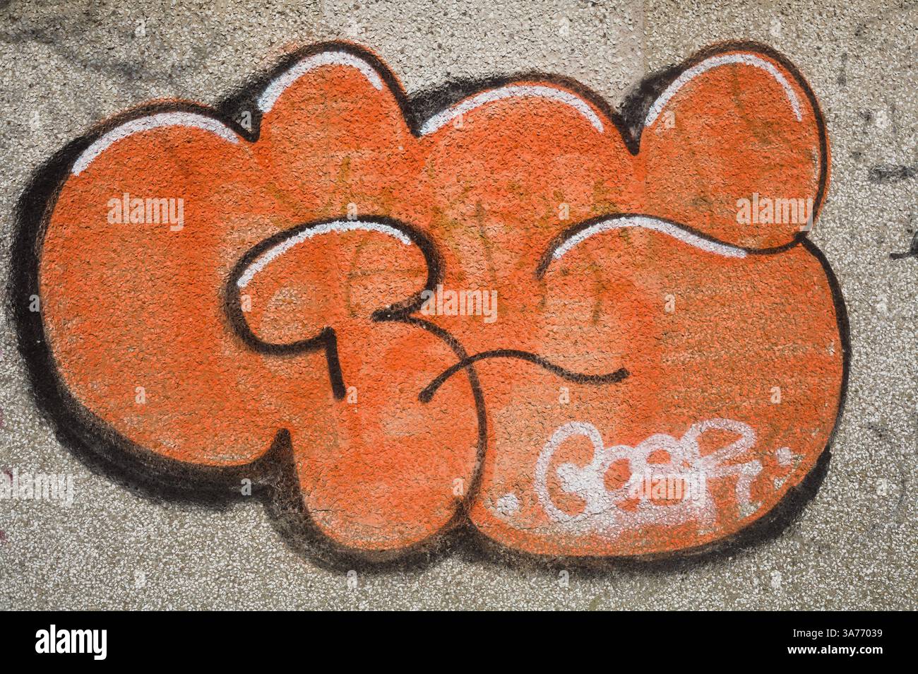 Orange blob spray painted graffiti on concrete wall in Comber Northern ...