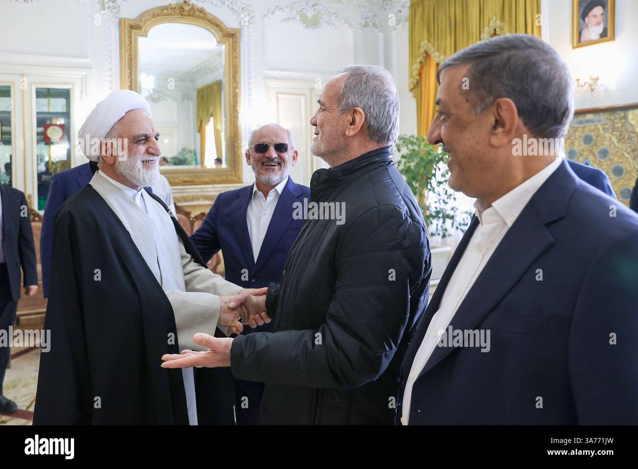 Tehran, Iran. 26th Mar, 2025. Iran's President MASOUD PEZESHKIAN (C ...