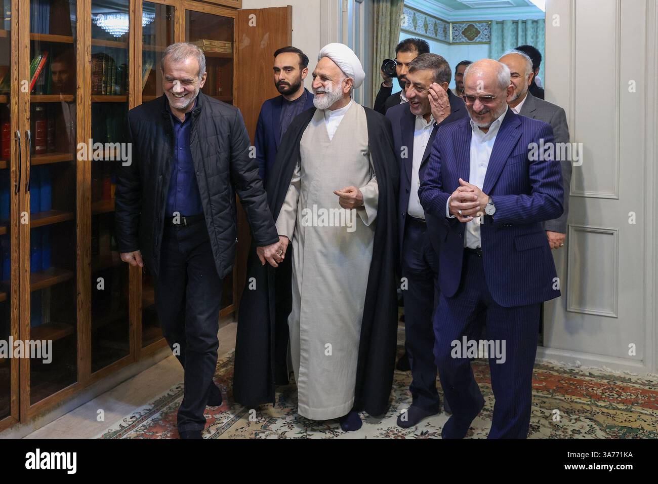 Tehran, Iran. 26th Mar, 2025. Iran's President MASOUD PEZESHKIAN (L ...