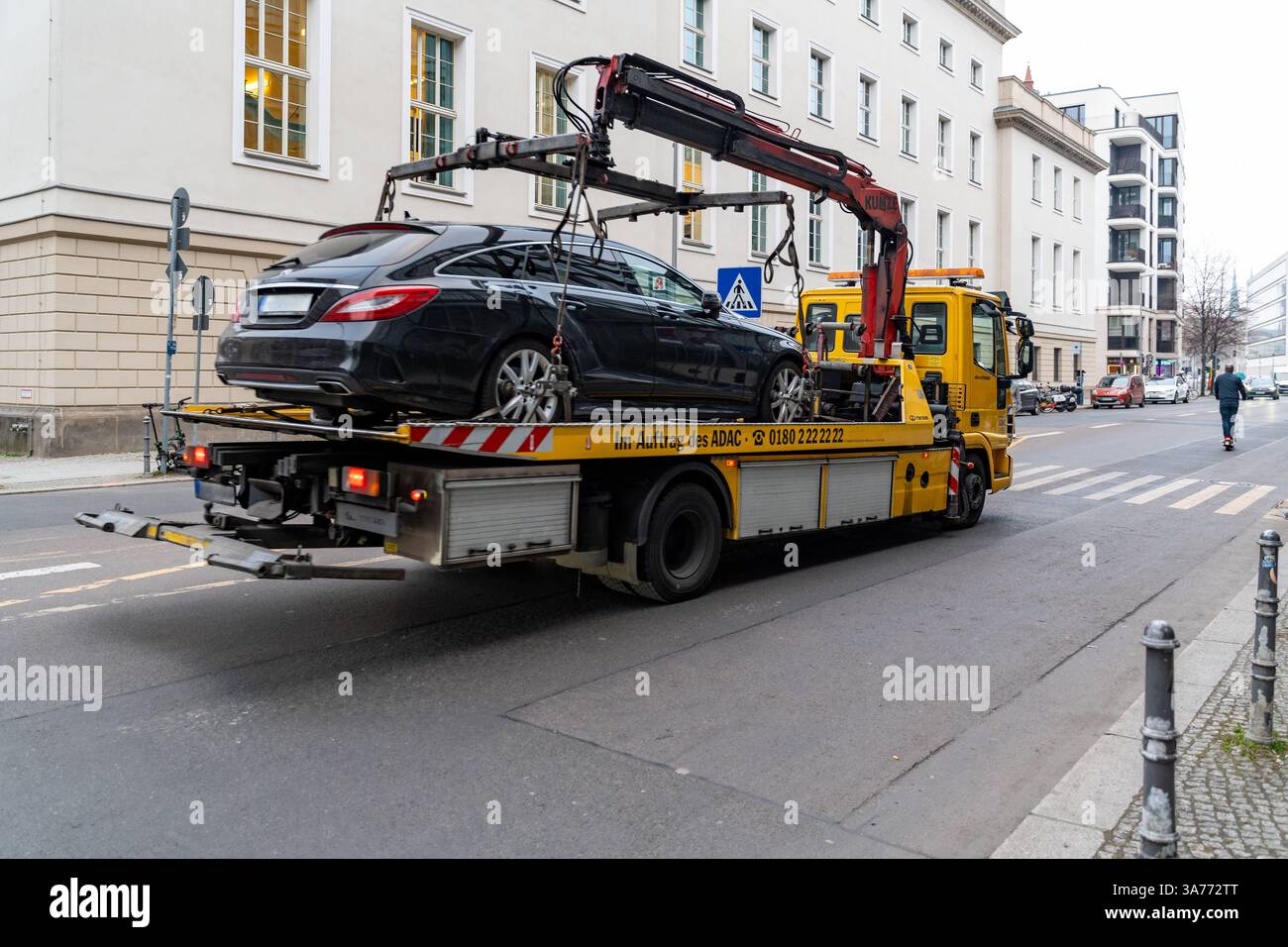 Berlin, Germany - March 24, 2025: Tow truck transports towed car ...