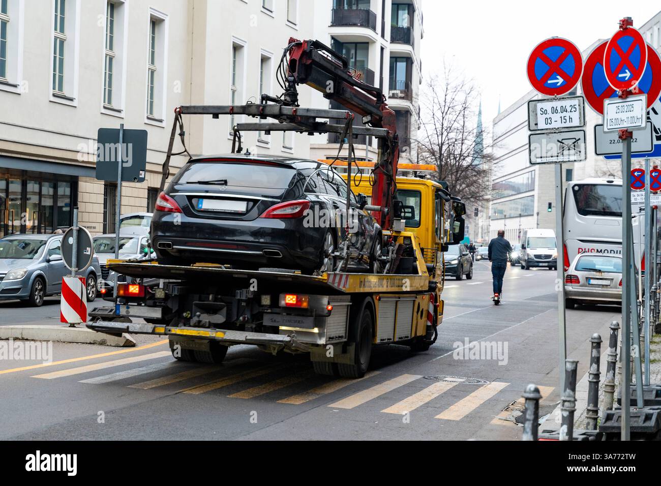 Berlin, Germany - March 24, 2025: Tow truck transports towed car ...