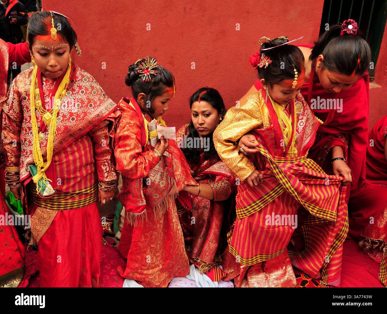 Feb. 2, 2013 - Kathmandu, Nepal - Newar girls are help by their mother ...