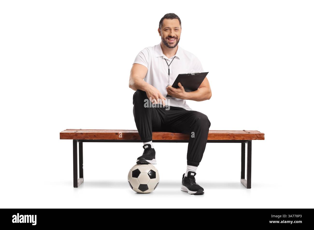 Football coach sitting on a bench and smiling isolated on white ...