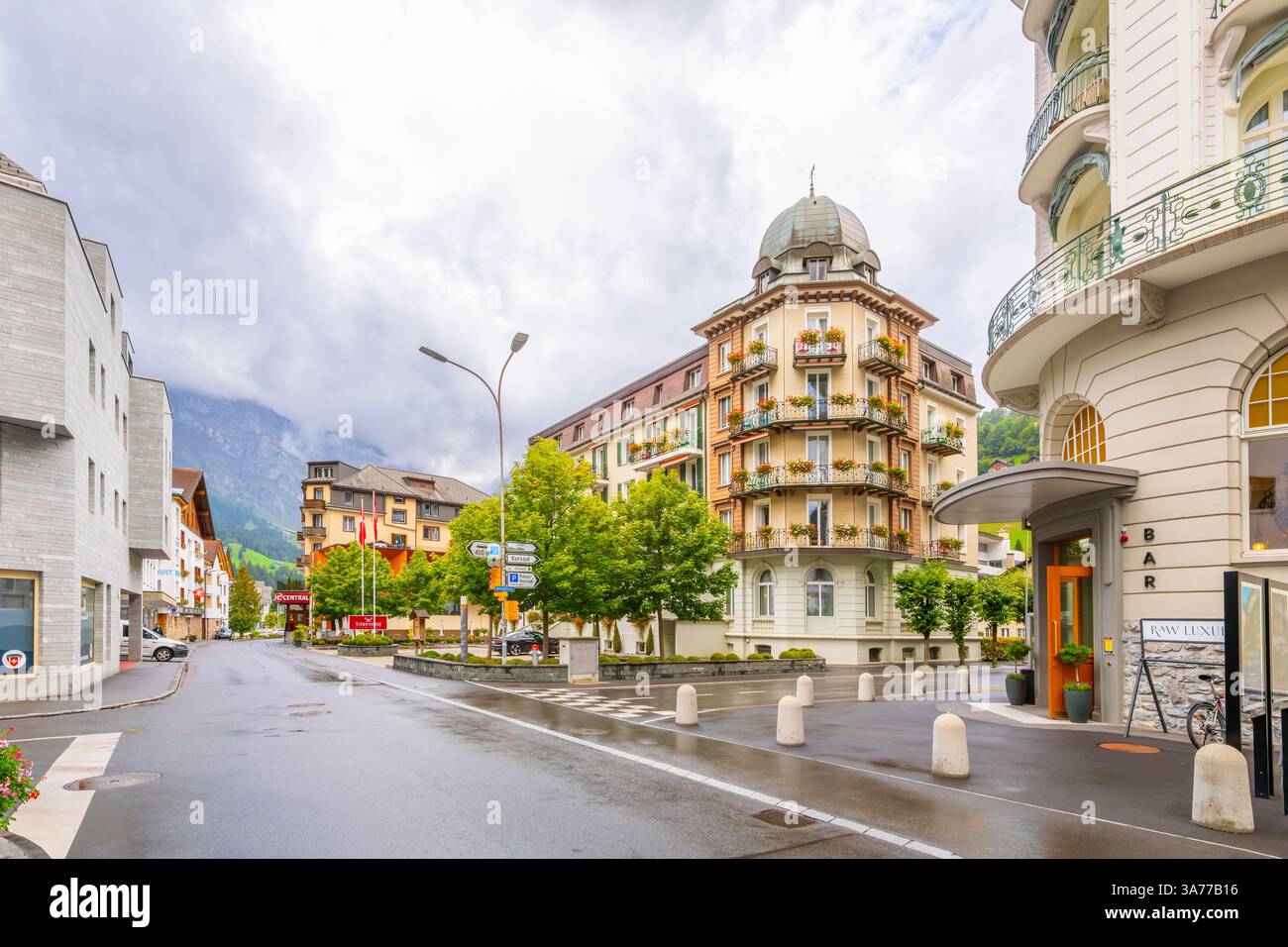 A picturesque street of colorful Swiss buildings of hotels and cafes in ...