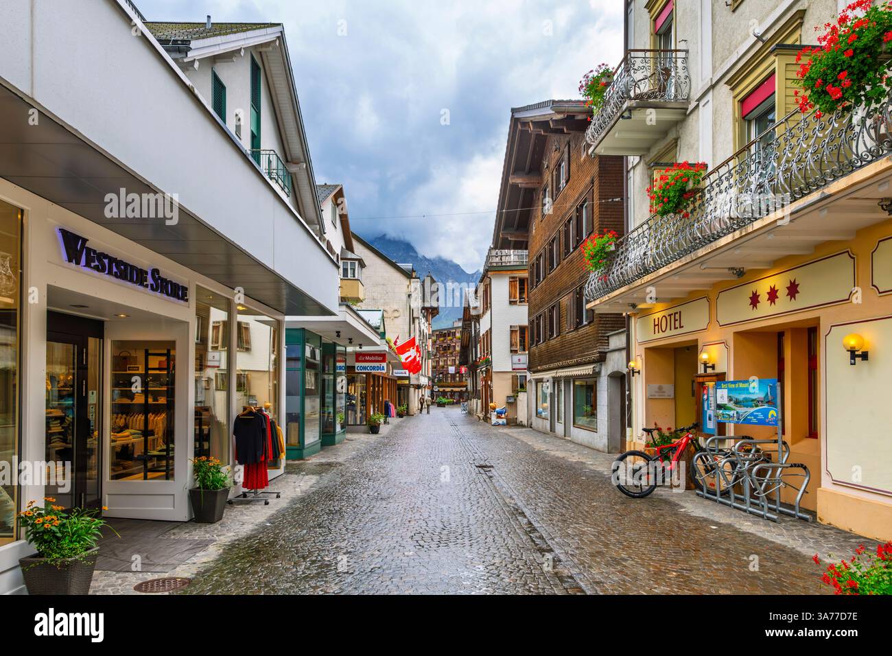 A picturesque street of colorful Swiss buildings of hotels and cafes in ...