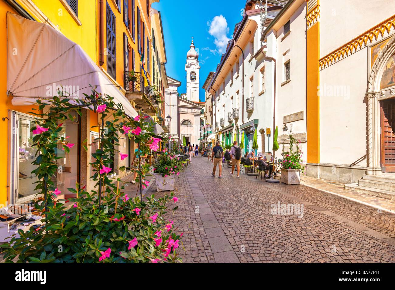 A picturesque cobblestone street of shops and sidewalk cafes with the ...