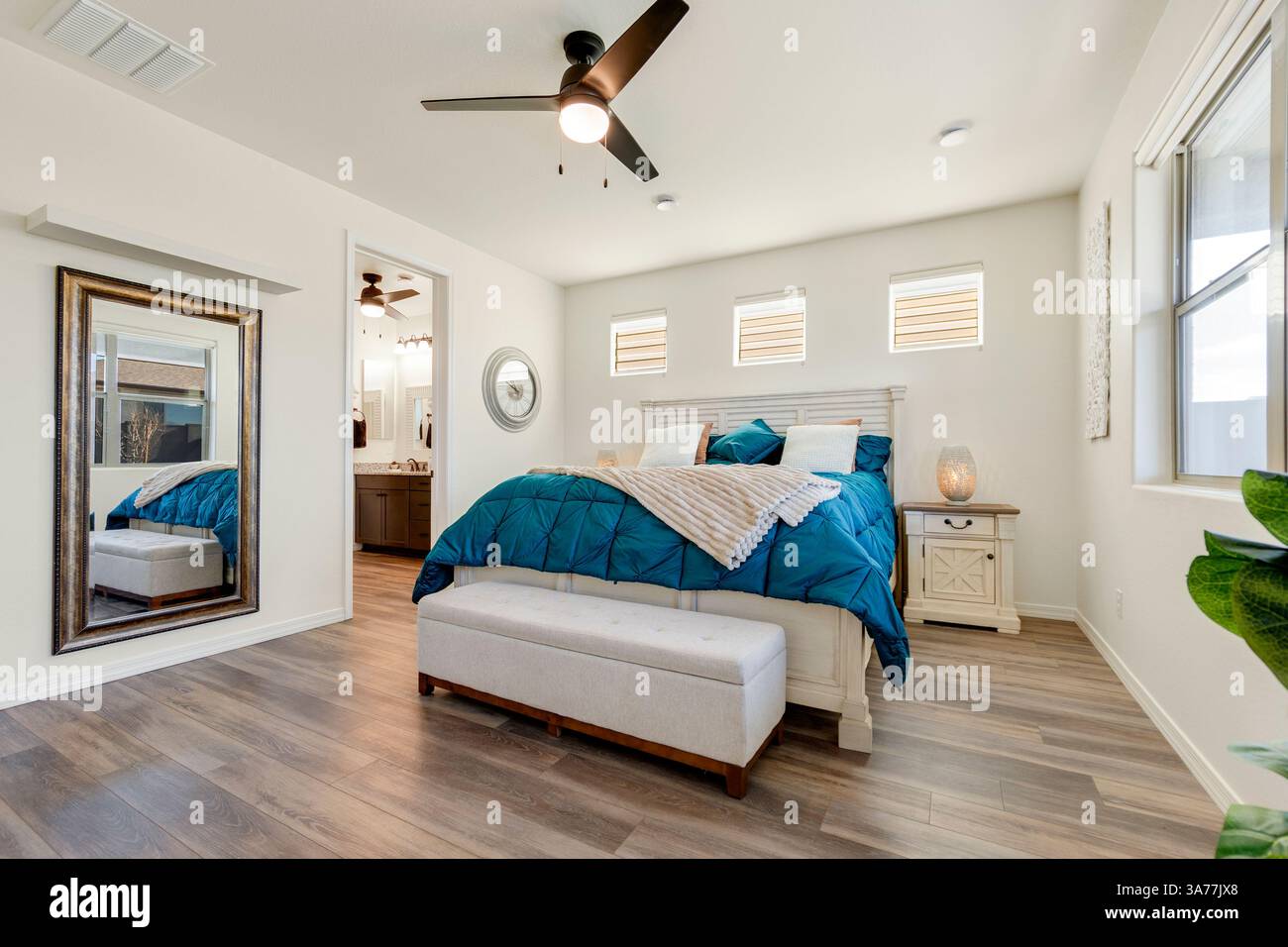 A beautifully styled bedroom featuring a ceiling fan that enhances ...