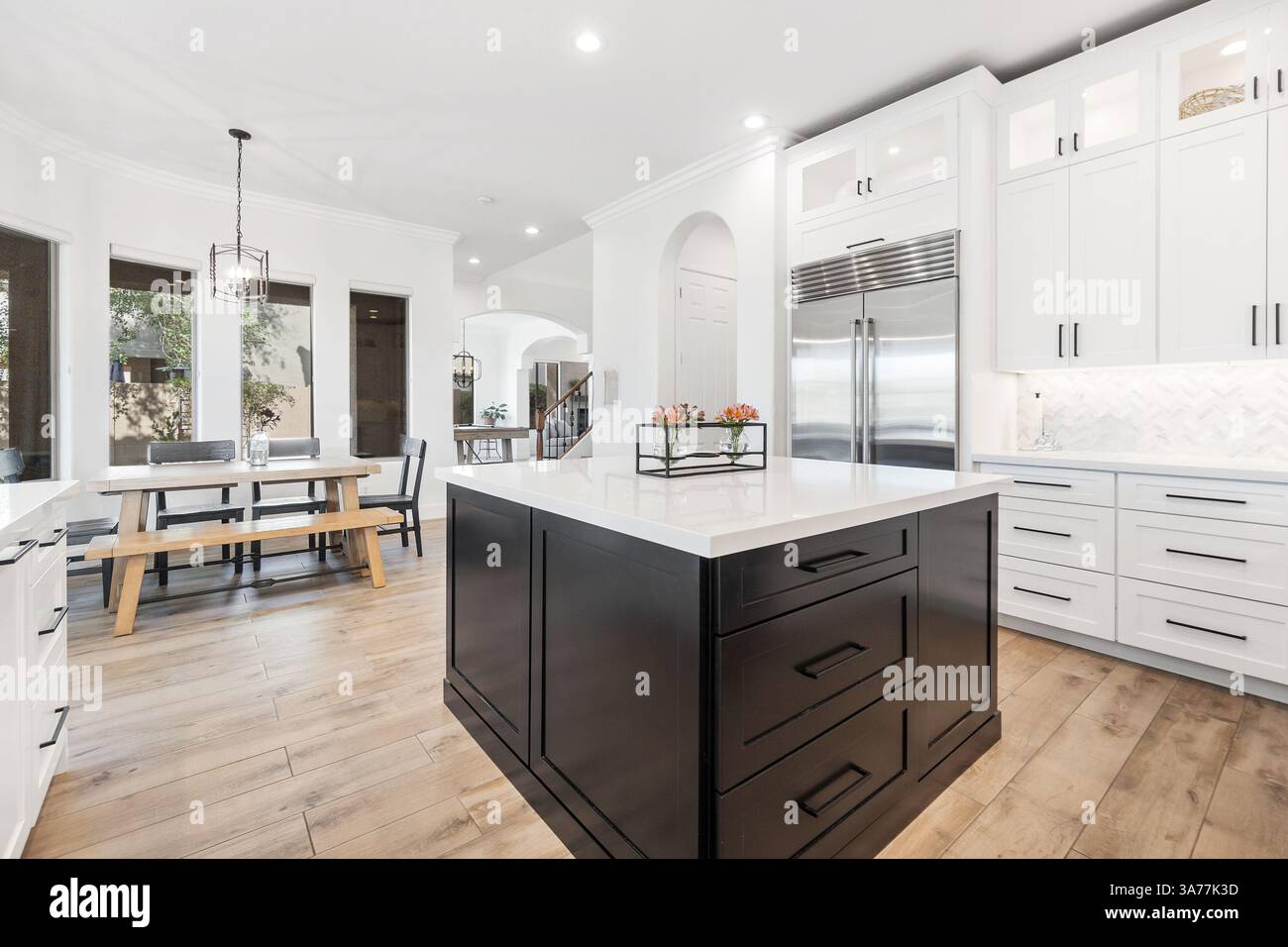 In the center of the kitchen, there exists a spacious island that draws ...