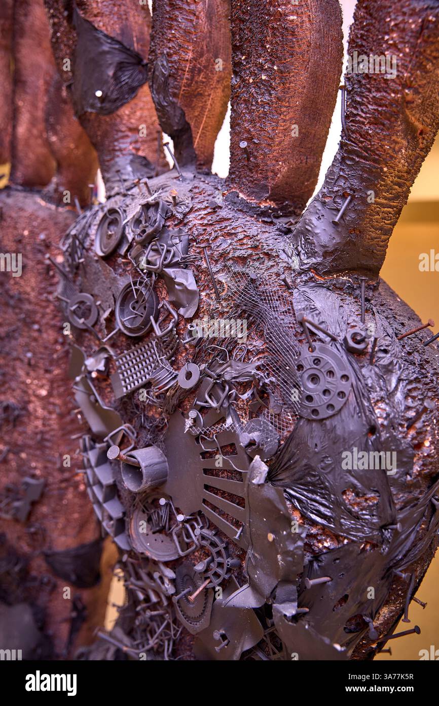 Intricate sculpture of hands intertwined with metal parts, evoking ...