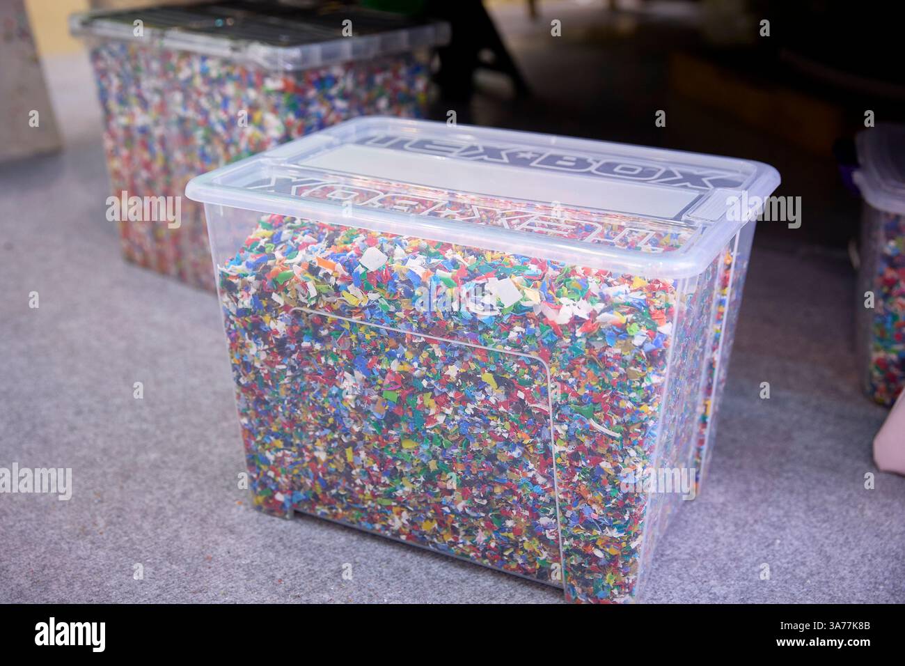 Recycled plastic confetti fills clear storage bins, suggesting ...
