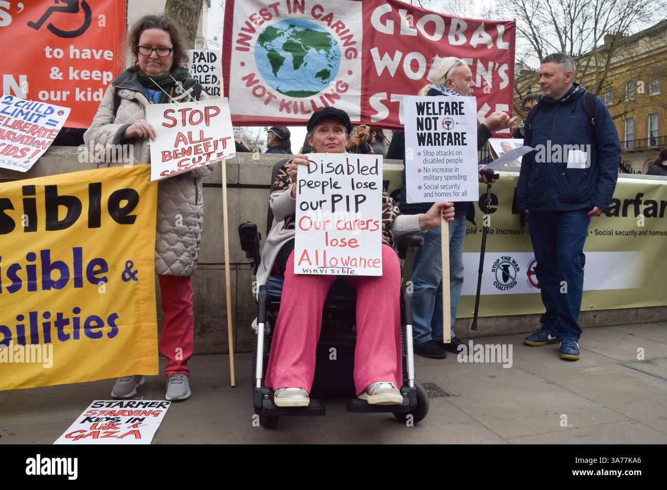 Protesters hold placards in support of Personal Independence Payment ...