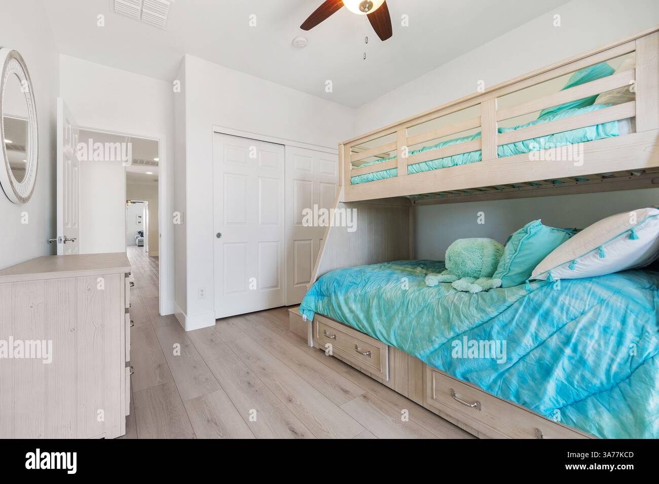 A cozy bedroom furnished with a stylish bunk bed and a cooling ceiling ...