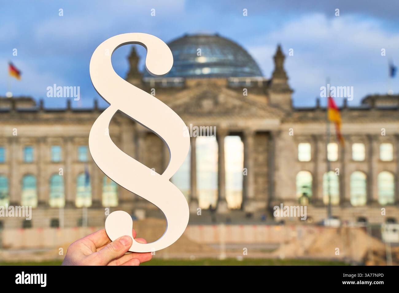 Berlin, Germany - March 26, 2025: A paragraph symbol is held in front ...