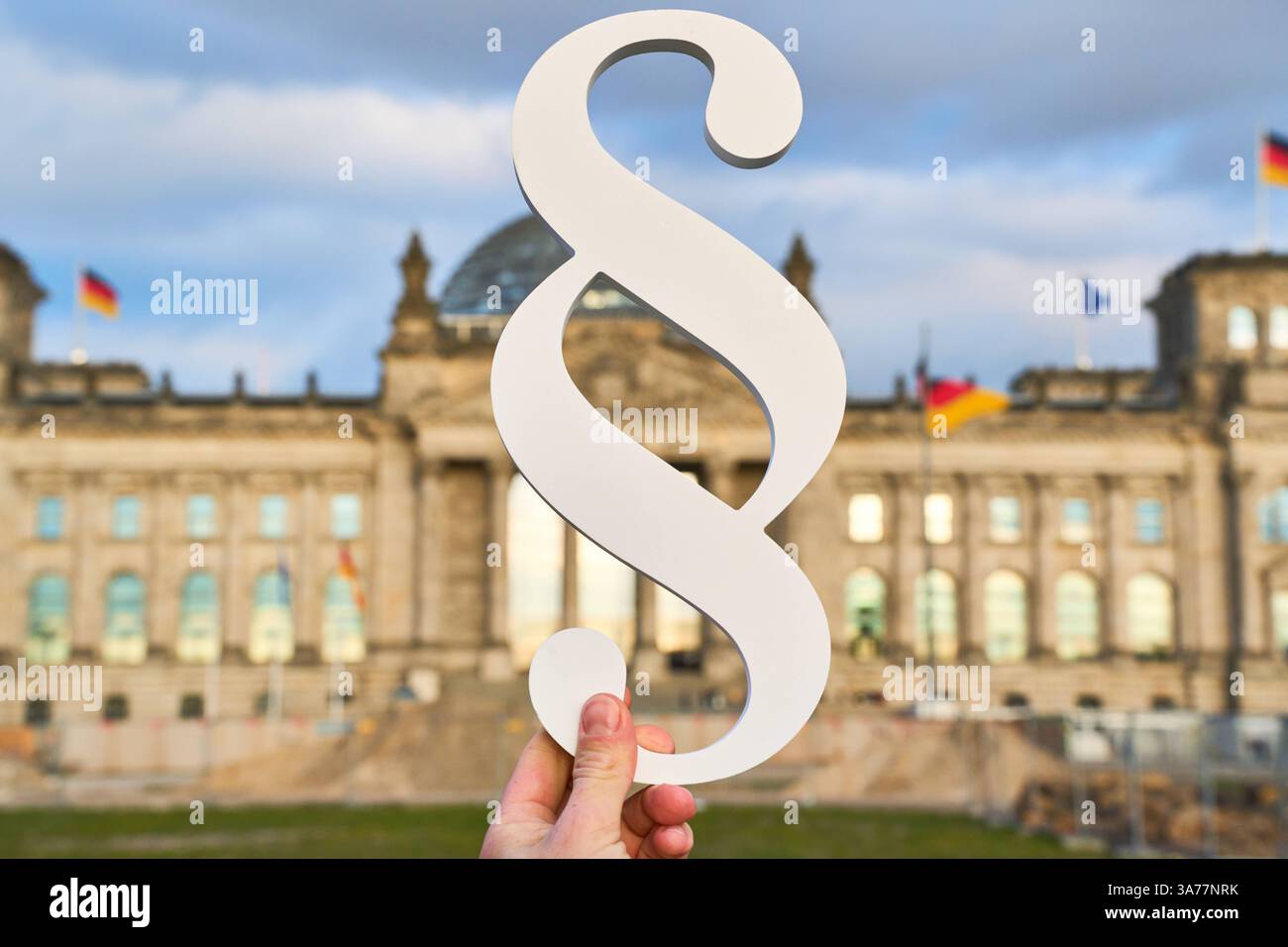 Berlin, Germany - March 26, 2025: A paragraph symbol is held in front ...