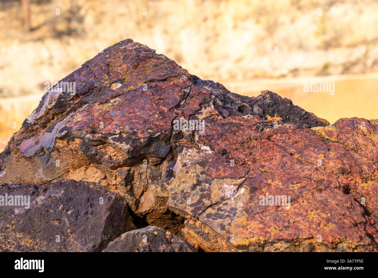 Eroded bauxite rock formation with bright orange colors in an abandoned ...
