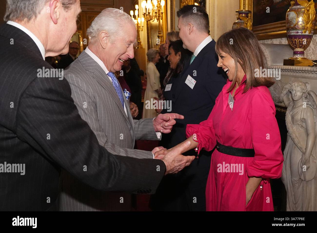King Charles III greets Riz Lateef during a reception at Buckingham ...