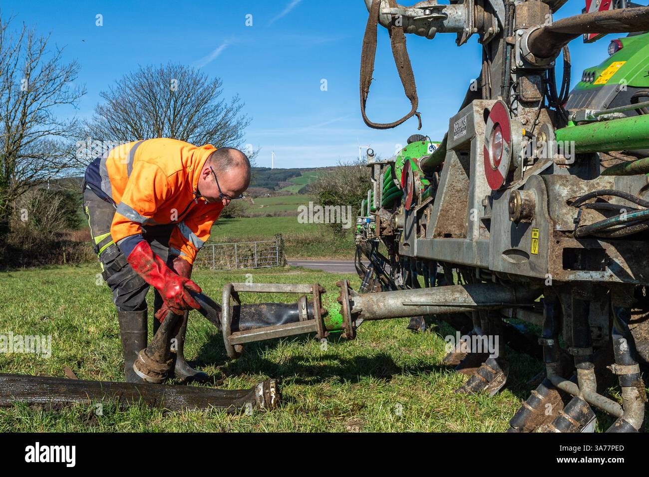 Farmer spreads slurry using an umbilical pump system and dribble bar ...