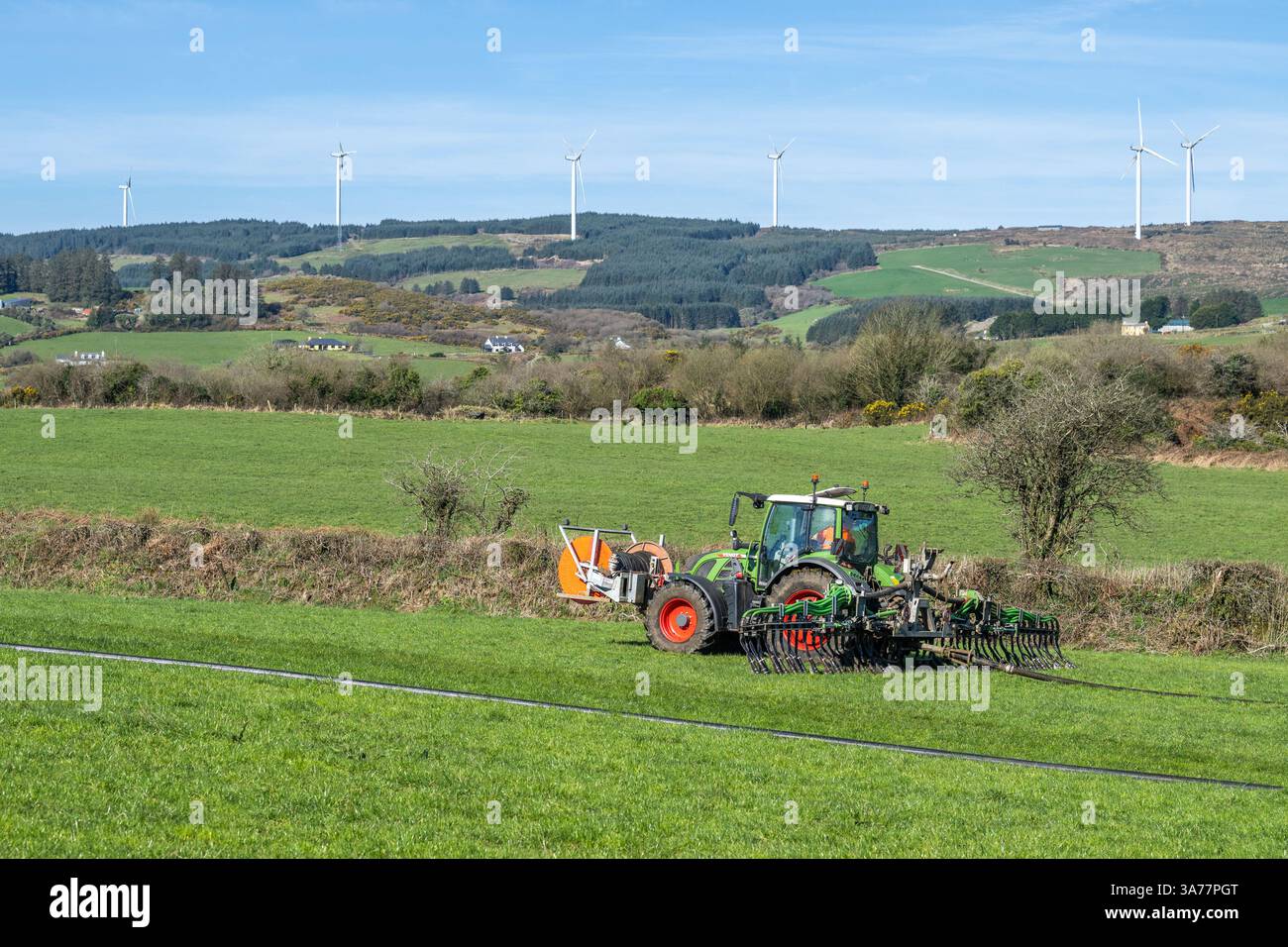 Farmer spreads slurry using an umbilical pump system and dribble bar ...