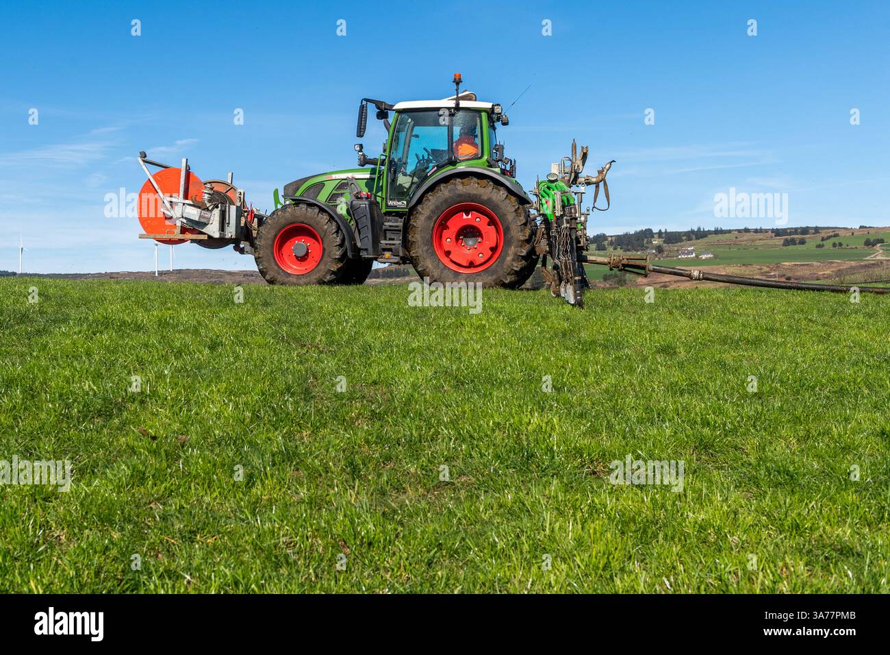 Farmer spreads slurry using an umbilical pump system and dribble bar ...