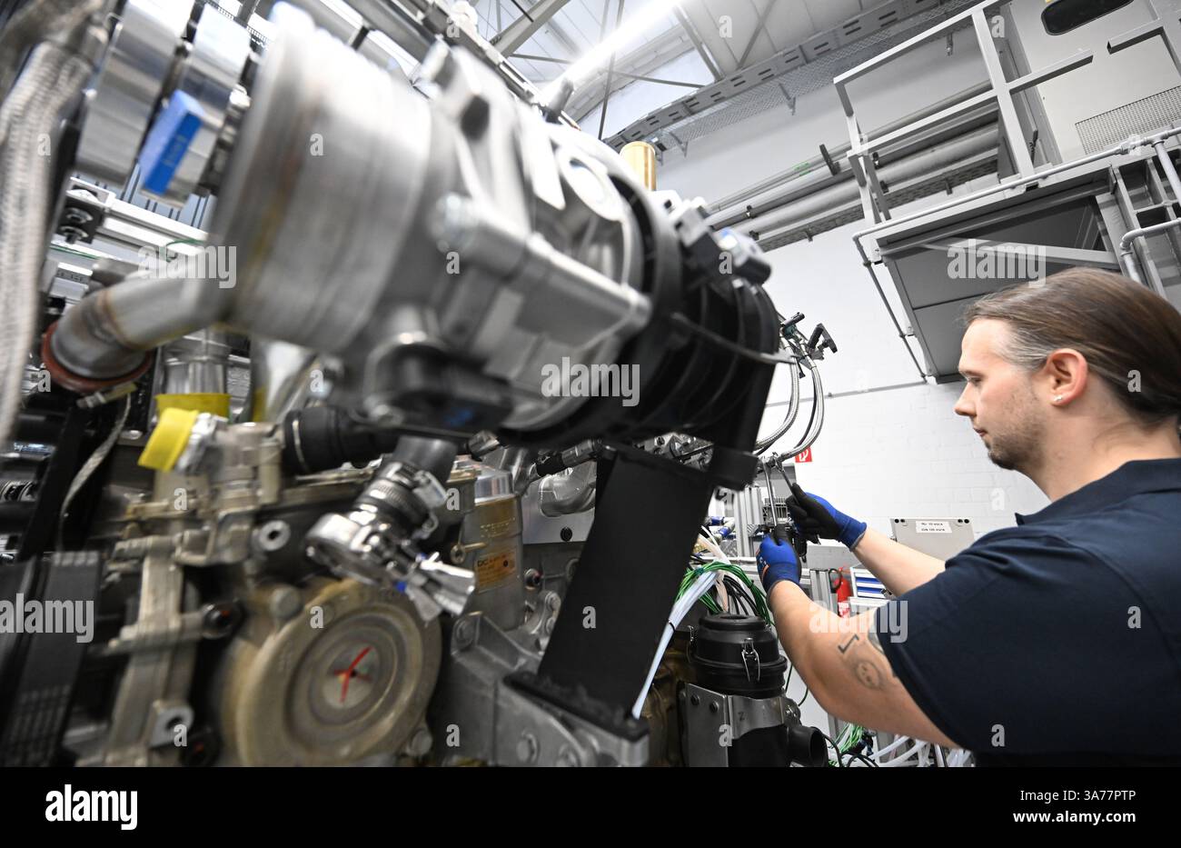 Stuttgart, Germany. 21st Mar, 2025. An employee of the automotive ...