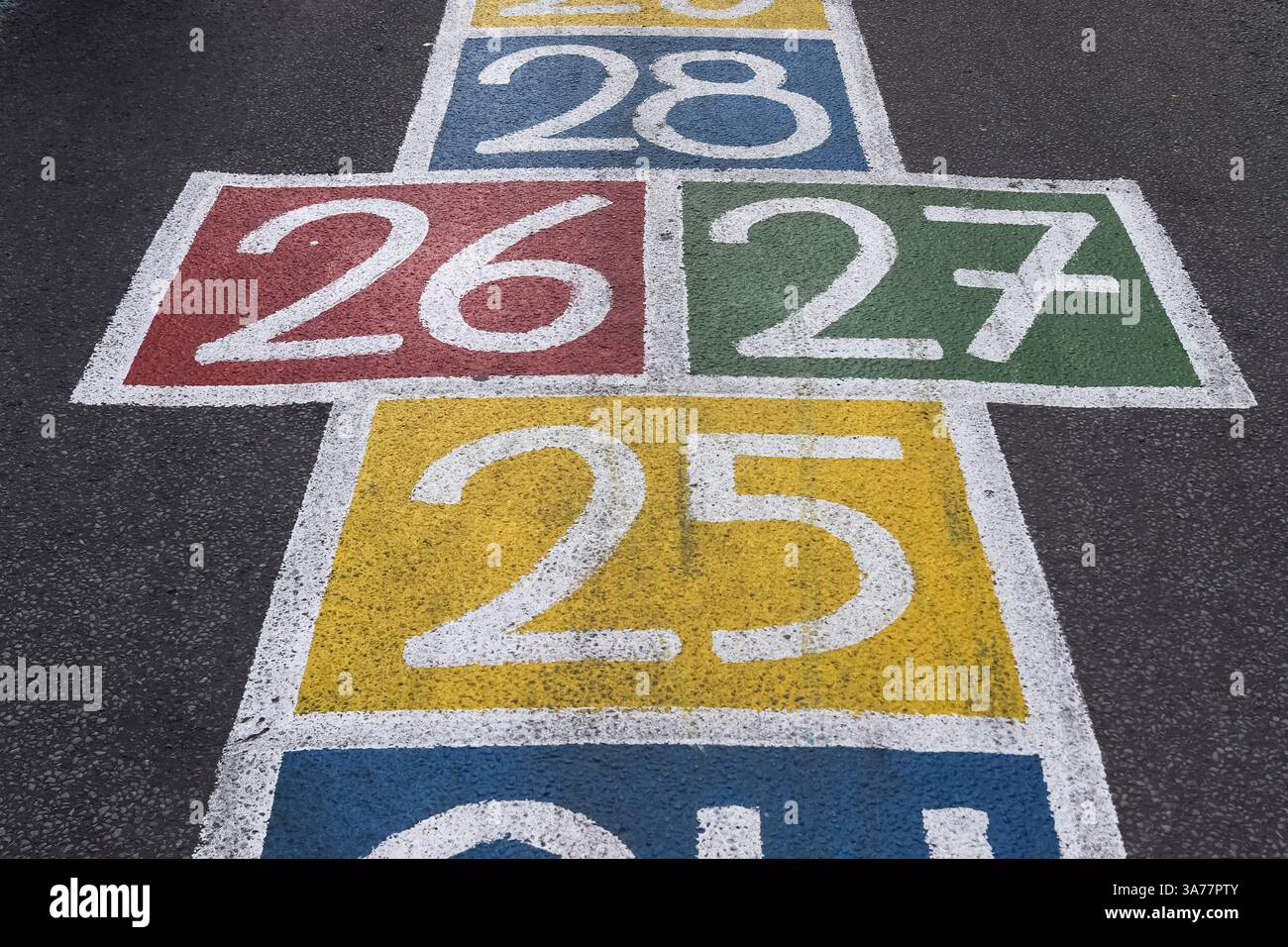Colorful hopscotch painted on asphalt with numbers from 25 to 28 ...