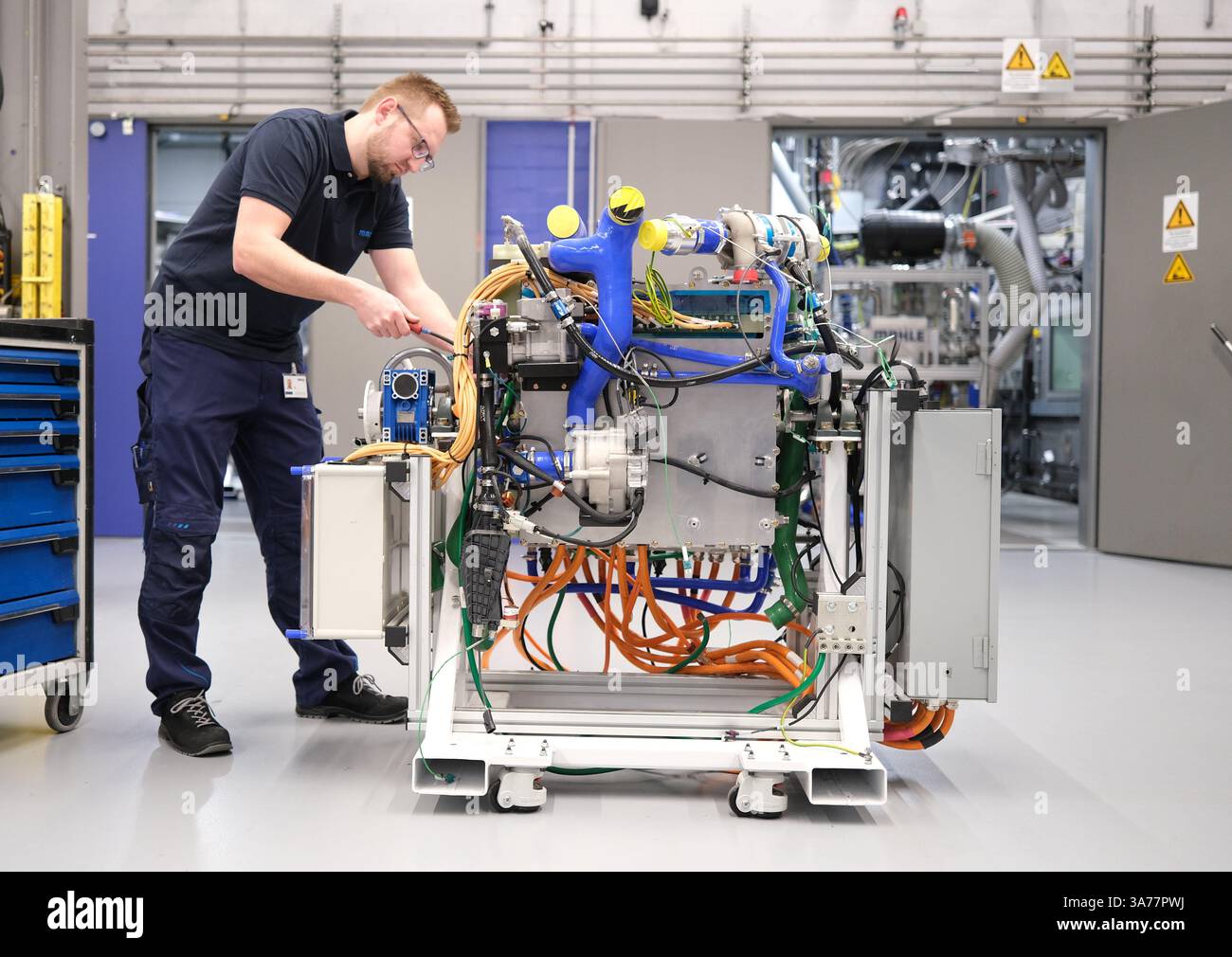 Stuttgart, Germany. 21st Mar, 2025. An employee of the automotive ...
