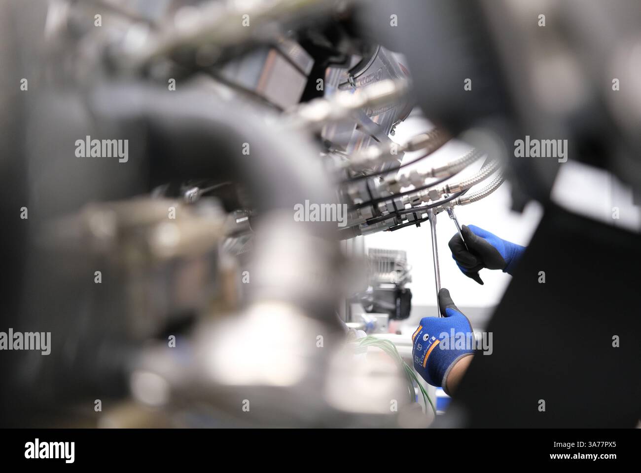 Stuttgart, Germany. 21st Mar, 2025. An employee of the automotive ...