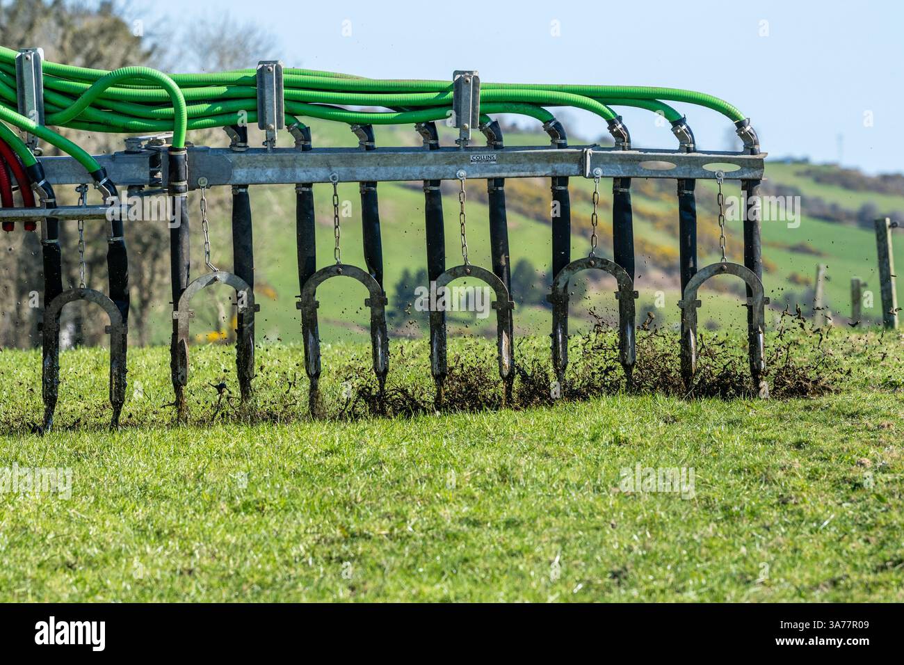 Farmer spreads slurry using an umbilical pump system and dribble bar ...