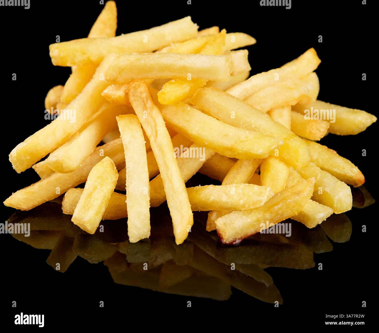 A pile of golden, crispy French fries with an oily sheen, displayed ...