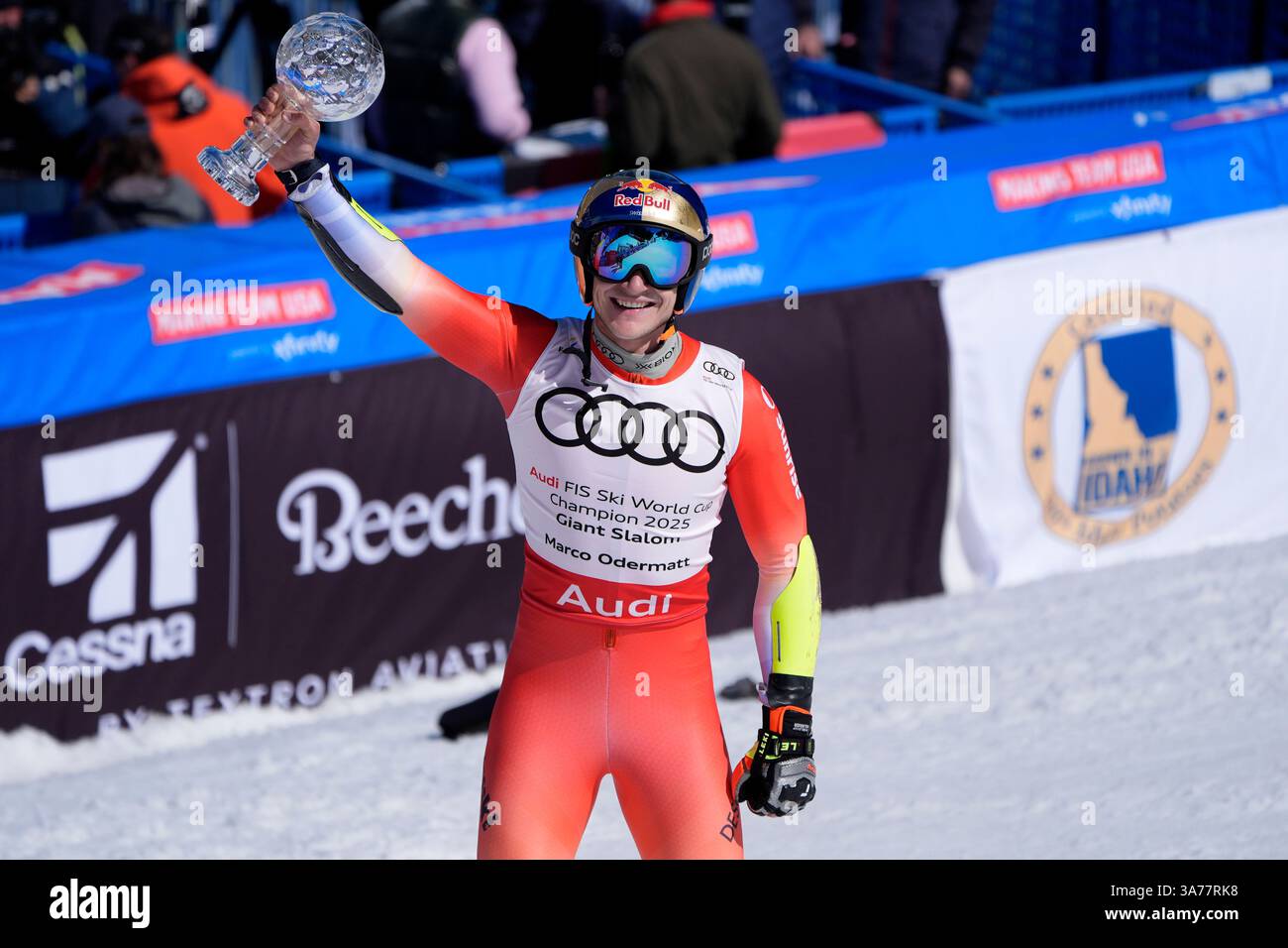 Switzerland's Marco Odermatt holds the trophy after winning the giant ...