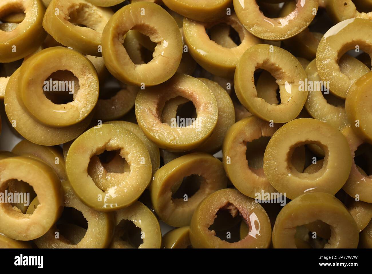Marinated green olive rings as background, top view Stock Photo - Alamy