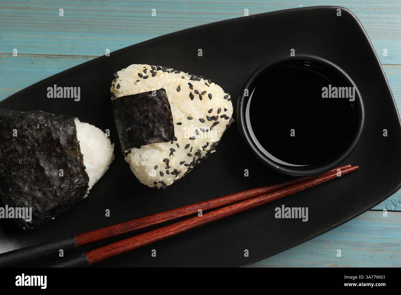 Rice balls (onigiri) served on light blue wooden table, top view ...