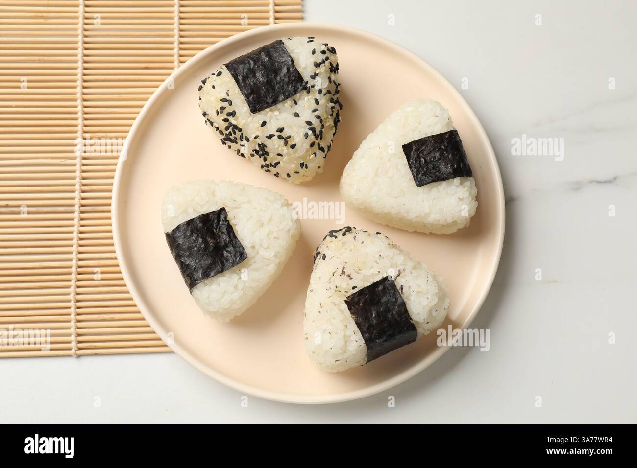 Rice balls (onigiri) on light table, top view. Traditional Japanese ...