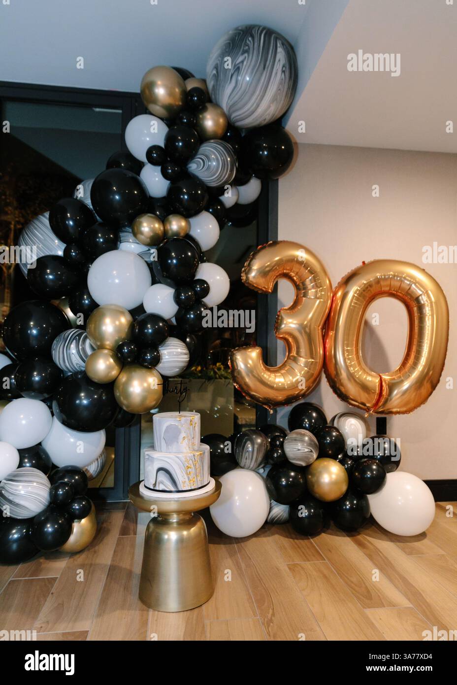 Guests enjoy a decorative setup for a 30th birthday with a striking ...