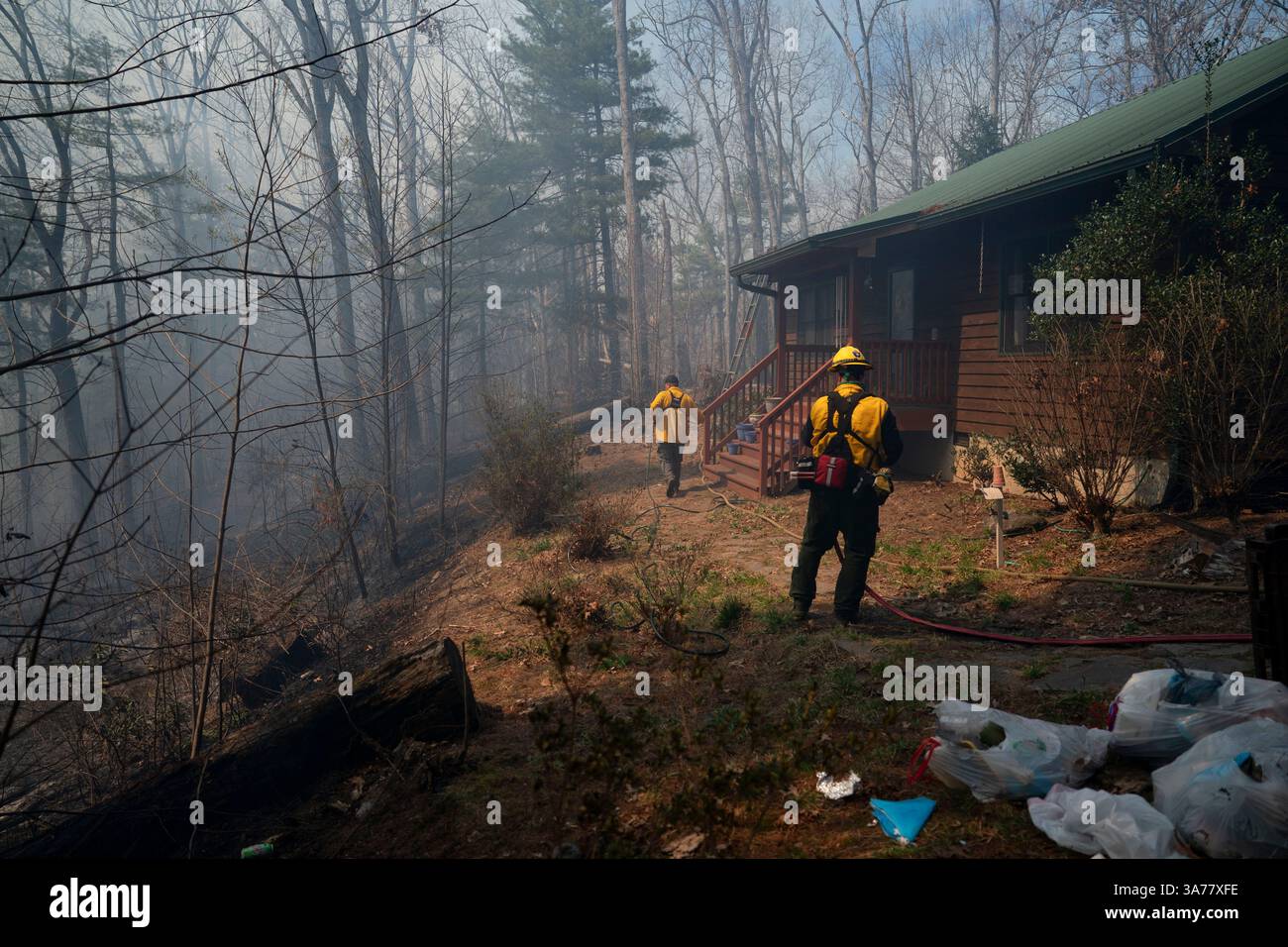Firefighters work to control the Black Cove Fire Wednesday, March 26, 2025, in Saluda, N.C.. (AP ...