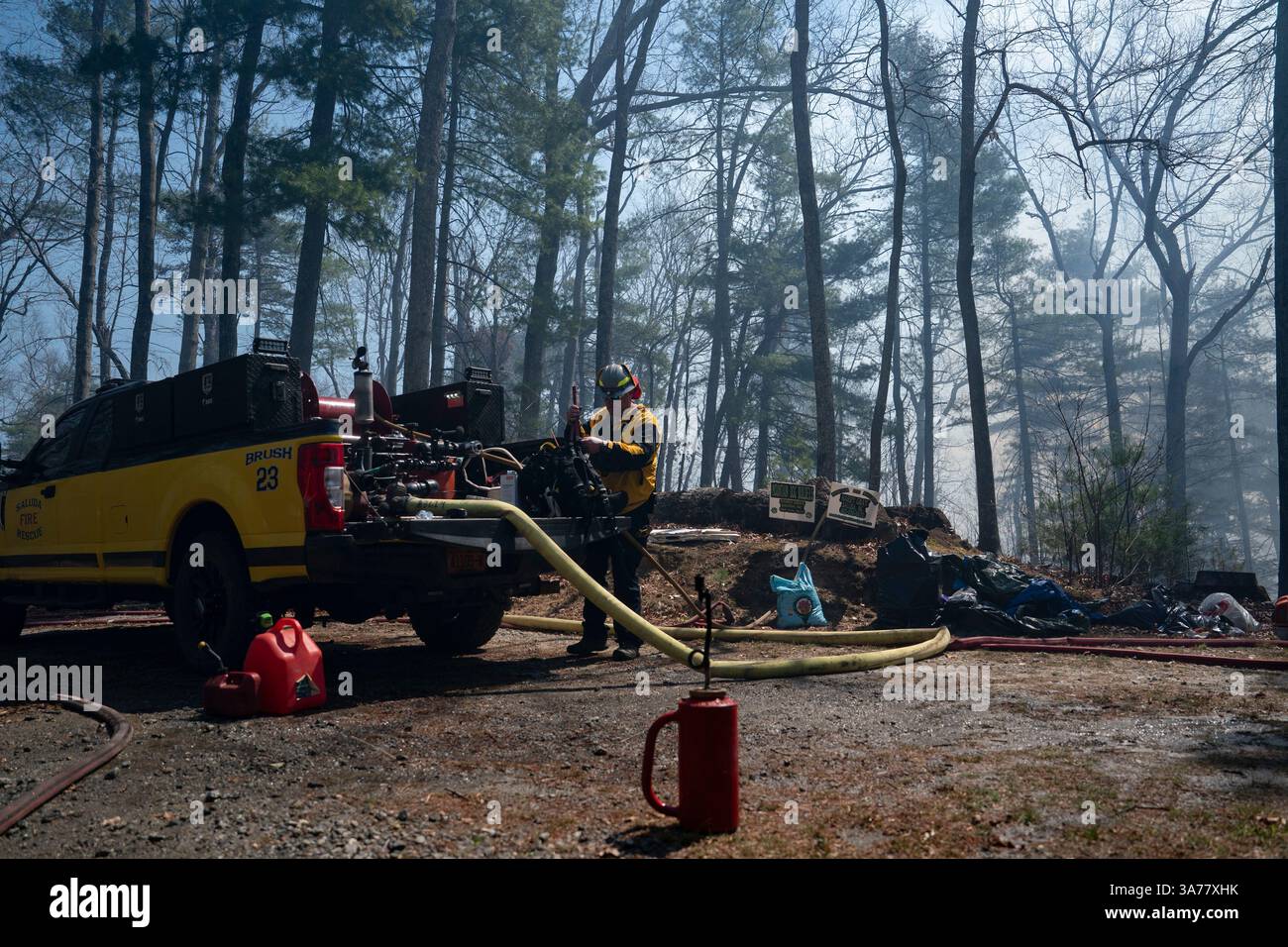 Firefighter John Ward works to control the Black Cove Fire Wednesday ...