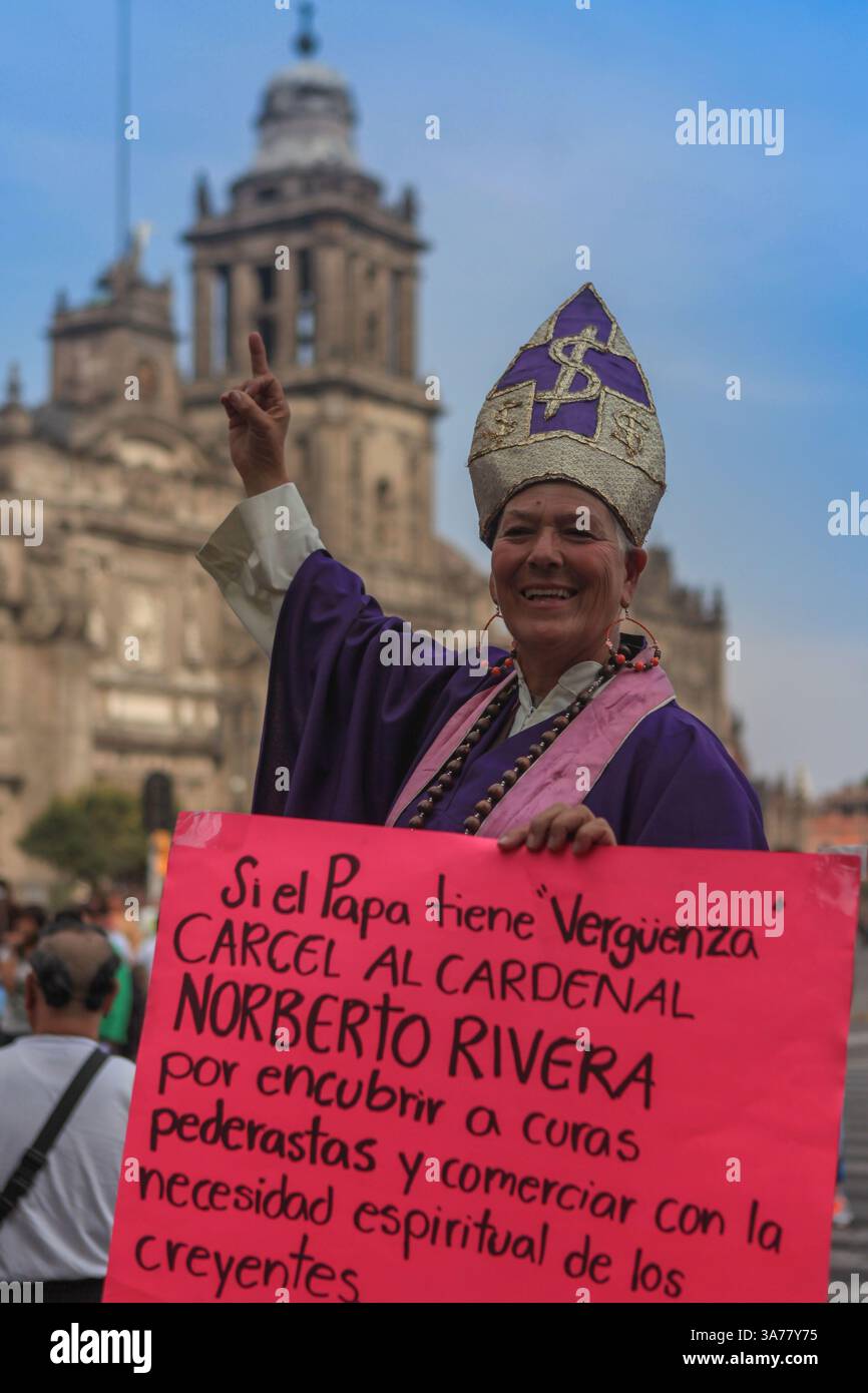 Woman dressed as Pope, making a finger sign and holding a pink ...