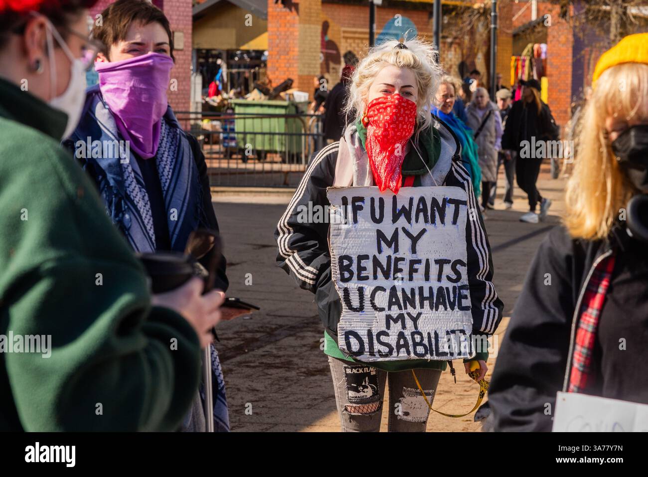 Leeds, UK. 26 MAR, 2025. Person holds a "If U want my benefits u can ...