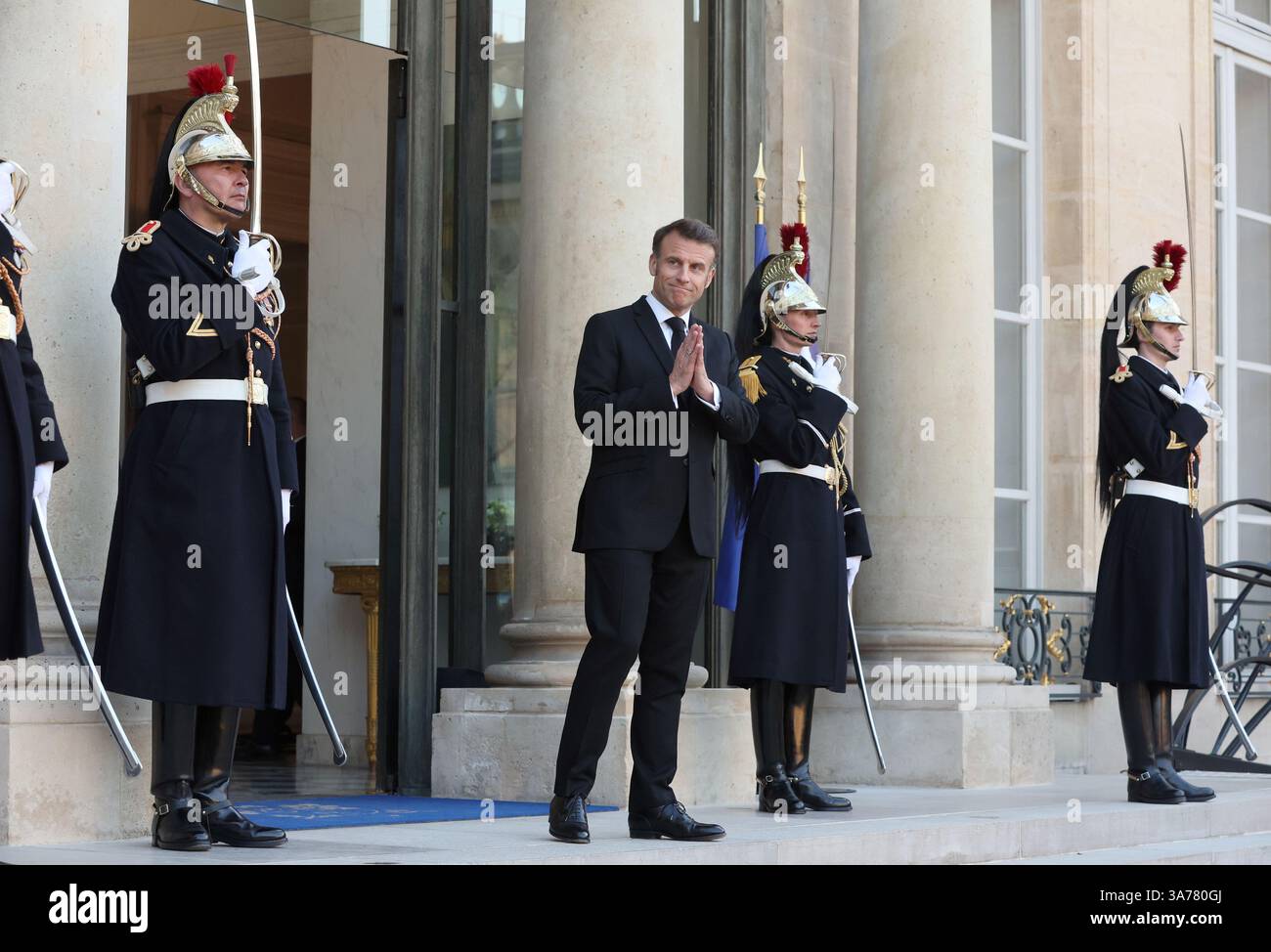 Paris, France. 26th Mar, 2025. French President Emmanuel waits to greet ...