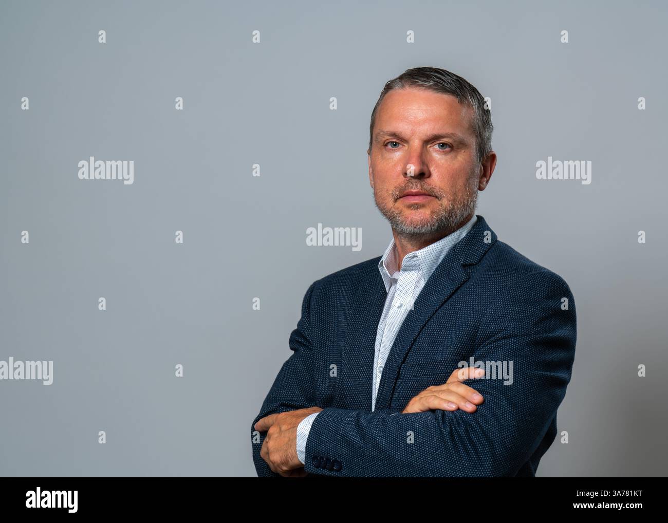 Middle-aged man with confident look in an elegant business suit with ...